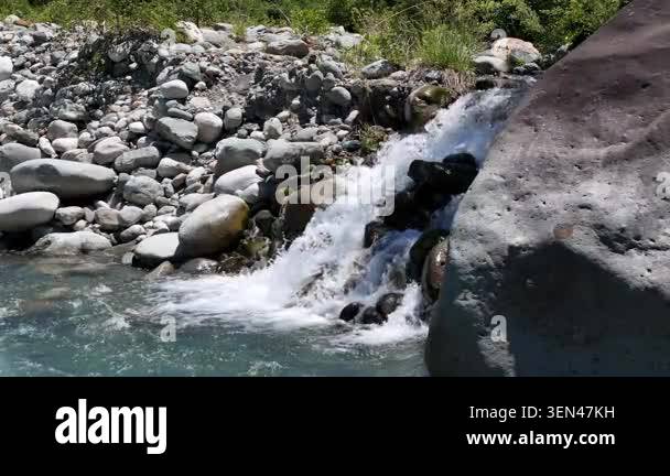Flowing water cascading over rocky terrain Stock Video Footage - Alamy