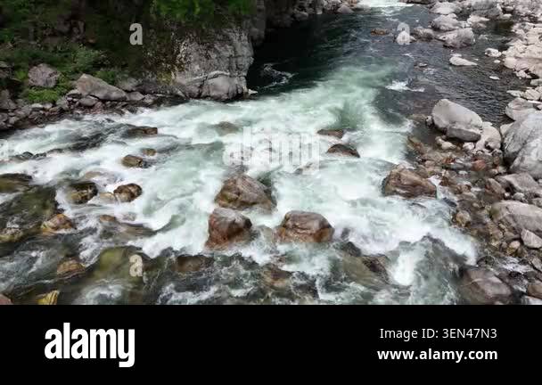 Rushing water flowing over rocky riverbed Stock Video Footage - Alamy