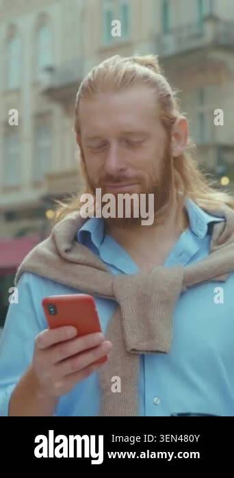 white man street corner sipping coffee, focused on phone screen between ...