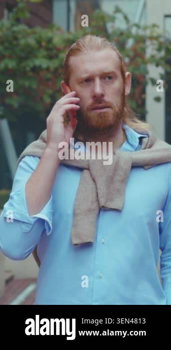white man urban phone call looking concerned, furrowed brow and tense ...