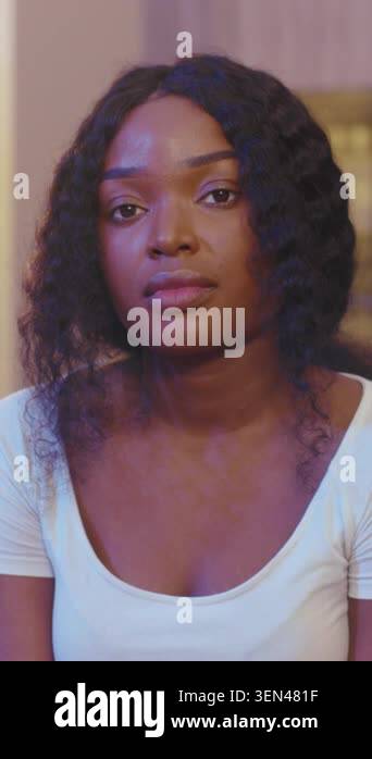 Contemplative black woman living room portrait, student reflecting ...