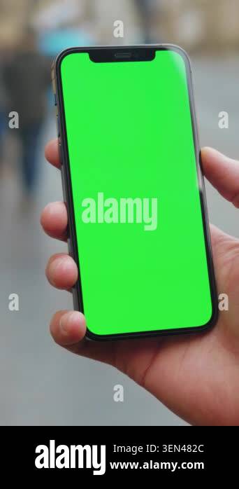 hand holding smartphone green screen reflection and glare from ...
