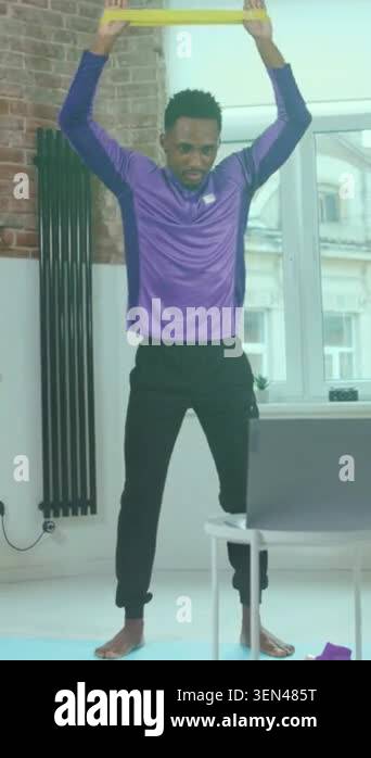 black man resistance band overhead stretch in bright apartment studio ...