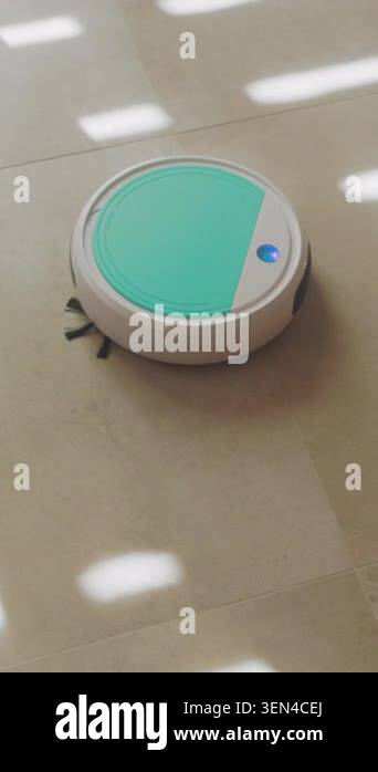 robot vacuum gliding across sunlit tile, small round cleaner crossing ...