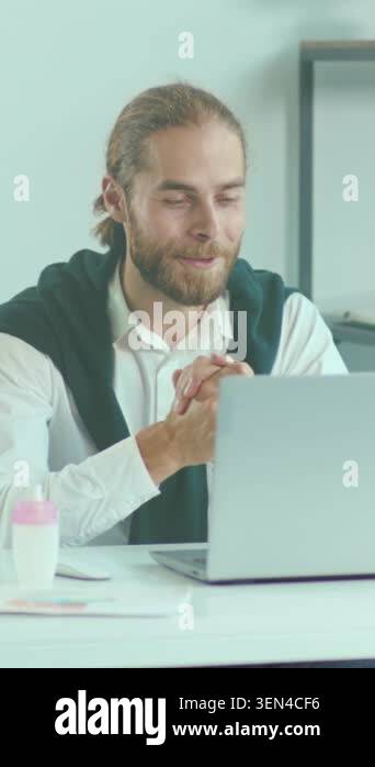 caucasian man on video call at laptop, laughing and gesturing, bright ...