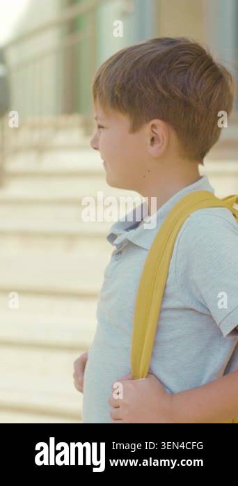 side profile white boy with backpack, eager student waiting on school ...