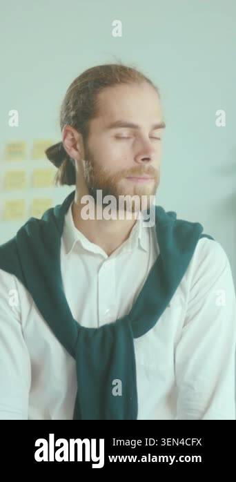 Pensive caucasian man with folded arms, studio office backdrop with ...