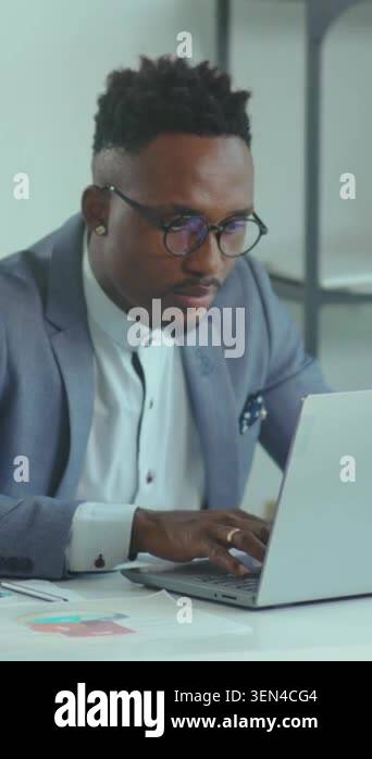 black entrepreneur at laptop stressed rubbing temple, financial analyst ...