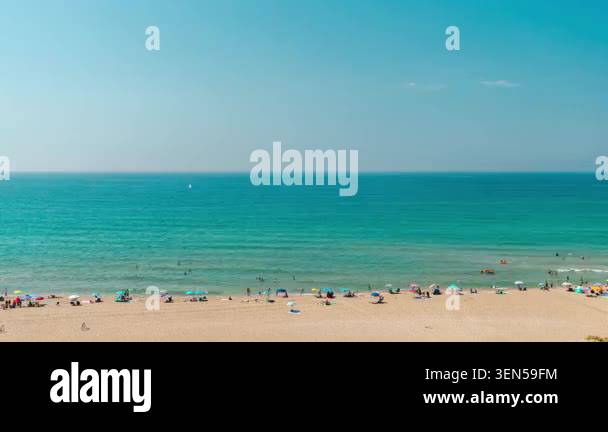 Time lapse day of beach activity from sunrise to sunset on ...