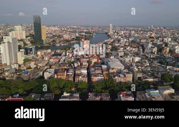 Bangkok cityscape with Chao Phraya River and dense urban skyline aerial ...