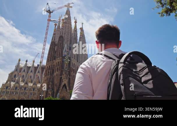 Male tourist with backpack visiting Sagrada Familia in Barcelona Spain ...