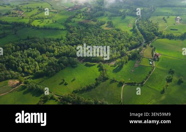 Aerial view of green Catalonia countryside with river, forest and rural ...