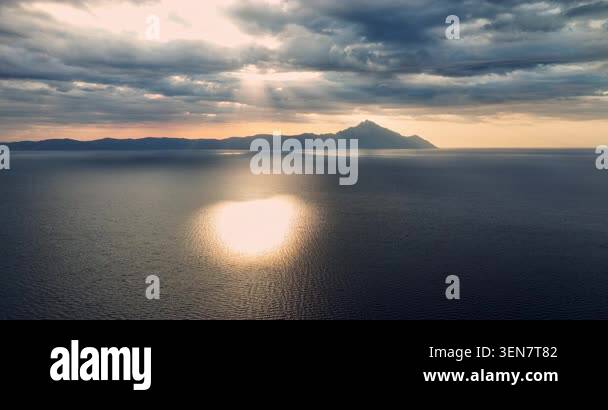 Dramatic sun rays over ocean and volcanic mountains in Madeira island ...