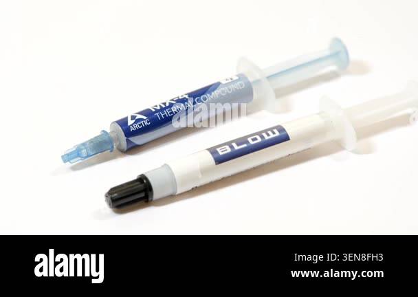Two branded thermal paste syringes for CPU and GPU cooling on white ...