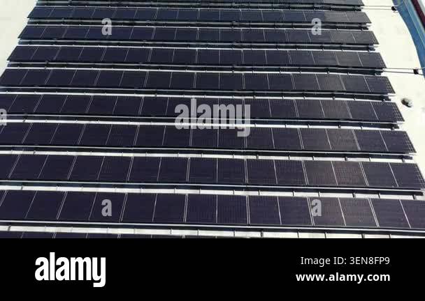 Aerial shoot of rooftop solar panels installed on commercial building ...