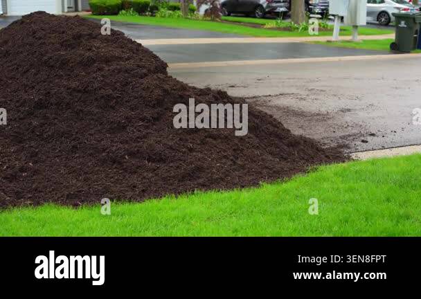 Pile of fresh mulch in residential neighborhood for landscaping project ...