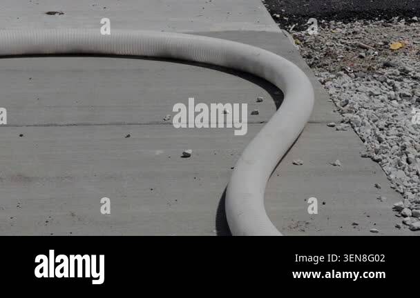 Insulation material being pumped through a hose at a residential ...