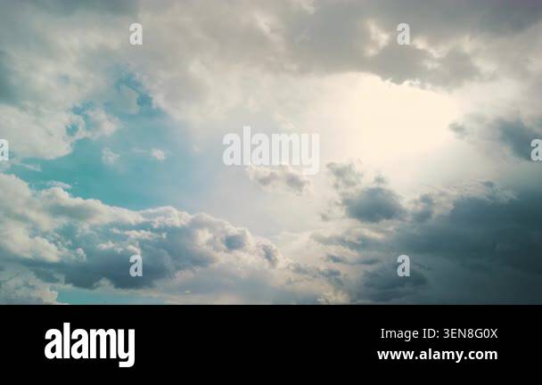 Storm clouds opening to bright sunlight in dynamic sky scene showing ...