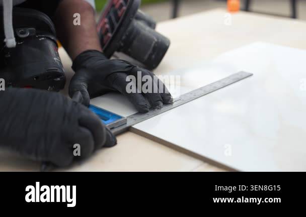 Tile labor measuring and marking ceramic tile before cutting process ...