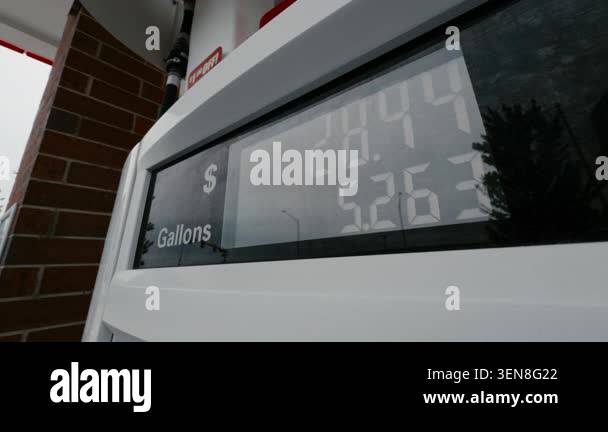 Gas station pump display showing fuel price and gallons during car gas ...