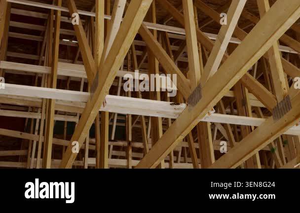 Wood framing a new residential house under construction with unfinished ...