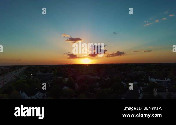 Beautiful blue and orange sunset with clouds glowing above distant ...