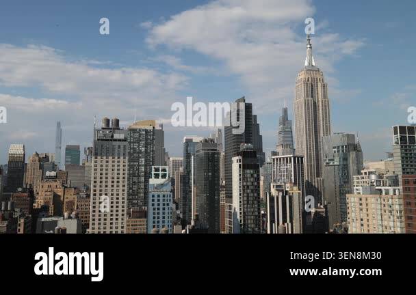 Dramatic clouds moving over the New York skyline and the empire state ...