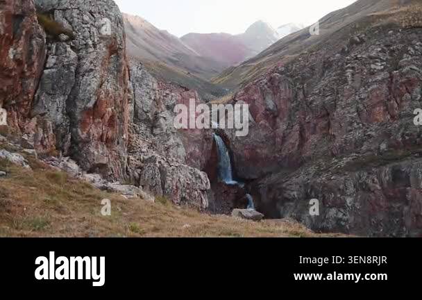 Scenic waterfall in deep rocky gorge near Lenin Peak Base Camp ...
