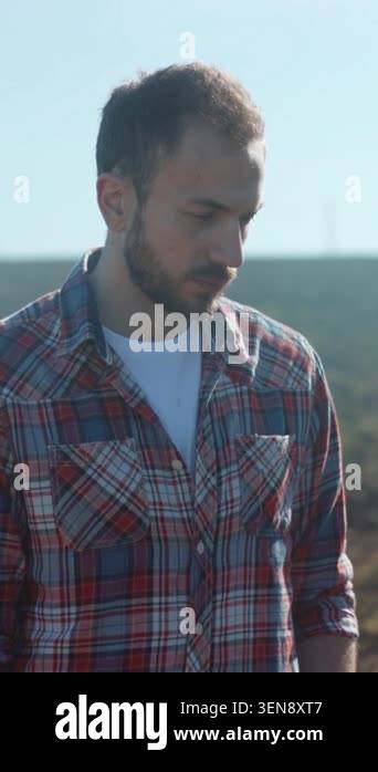 white man in plaid shirt standing field, closeup and mid shots ...