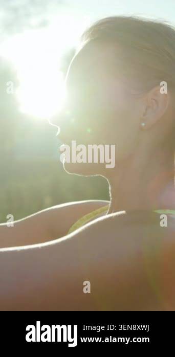 caucasian woman resistance band training outdoors at sunrise, focused ...