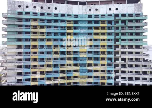 Aerial drone footage of an abandoned unfinished residential building ...