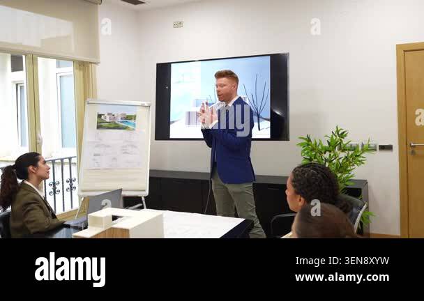 Male architect leading a business presentation in a modern office ...