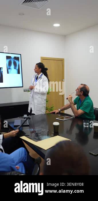 Professional medical team of doctors and surgeons discussing a chest x ...