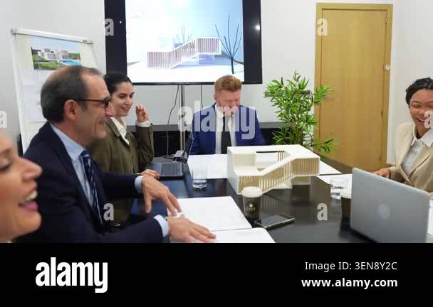 Professional team of diverse architects and clients discussing an ...