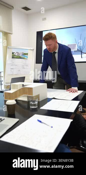 Confident male architect discussing a new building project with ...