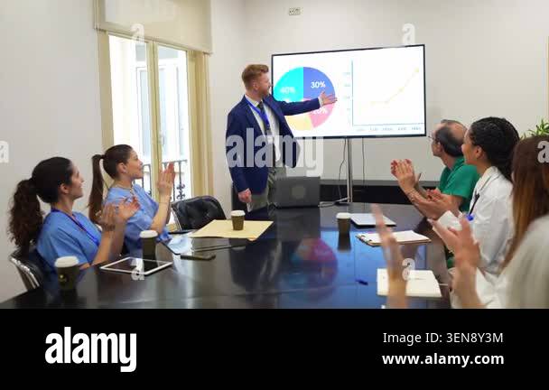 Businessman making a presentation about medical results to a team of ...