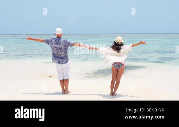 Happy carefree young couple holding hands outstretched arms on white ...