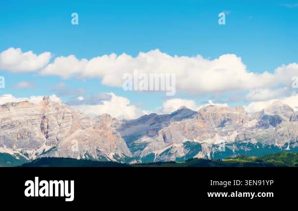 Timelapse Dolomites mountain range Italy jagged peaks moving clouds ...
