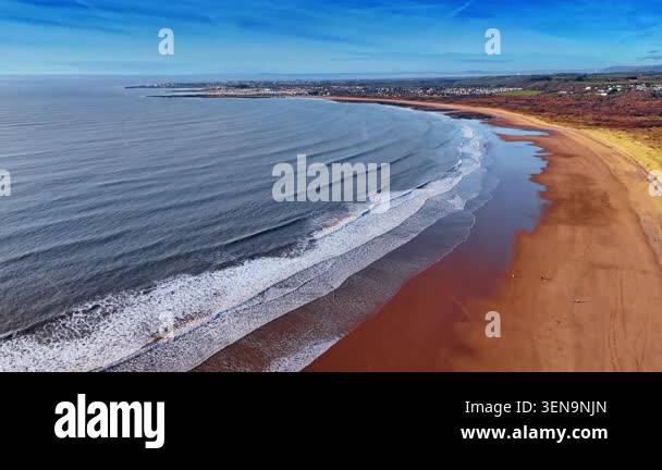 Aerial View of Long Sandy Beach with Rolling Waves and Coastal Town. A ...