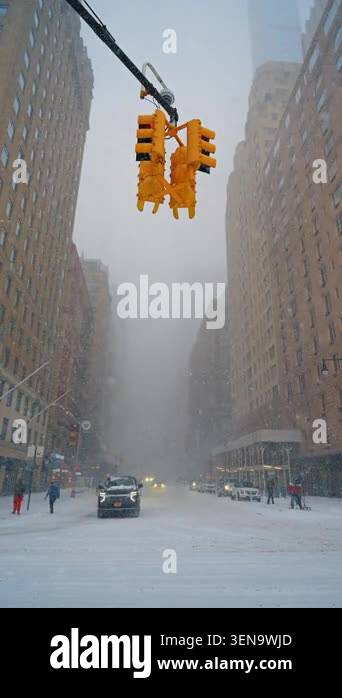New York, USA, 9 January 2026: Hanging traffic lights over snowy New ...
