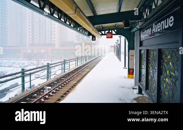 Standing on the open-air subway station on winter day. Snow blizzard ...