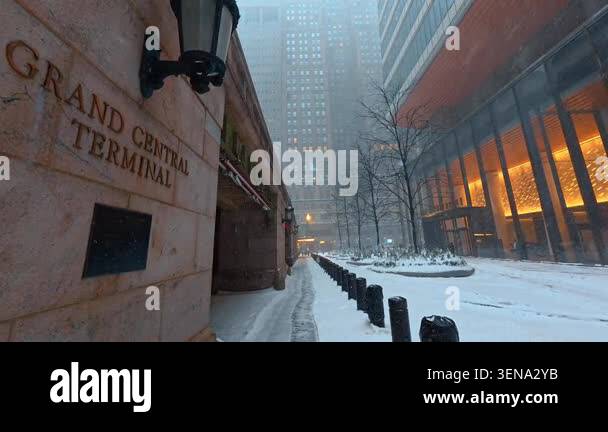 Snow covers the street of New York City, USA. View on the wall of the ...