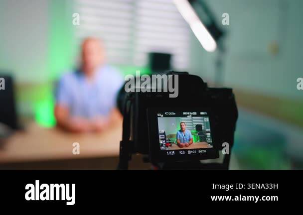 Camera display showing recording indicator during desk interview. Live ...