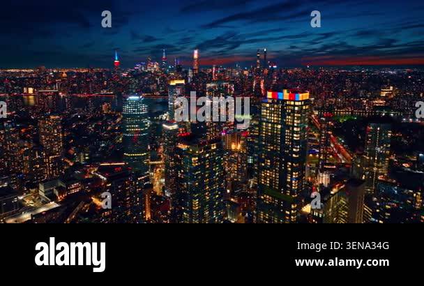 Modern cityscape of high-rises and skyscrapers at night. Drone footage ...