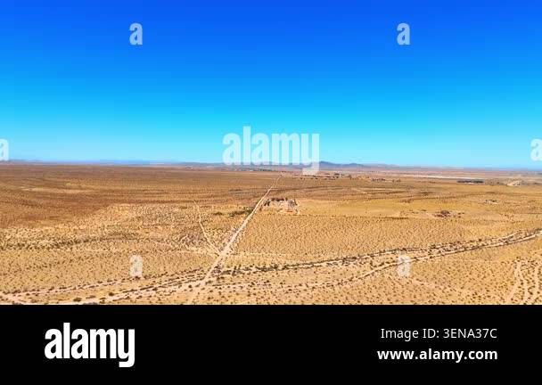 Flight over the road crossing the arid Mojave Desert. Contrasting ...