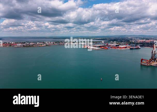 Footage over the waterscape along the large commercial seaport terminal ...