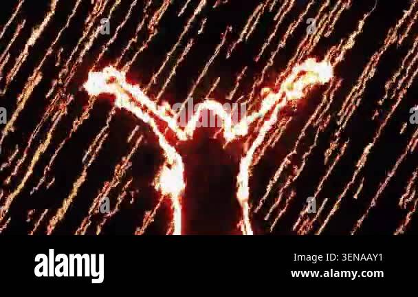 Fiery figure raises arms in silhouette against a backdrop of glowing ...