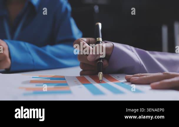 business woman hand holding a pen to calculate the financial data on ...