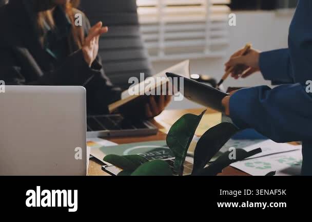young businesswoman writing on paper while working at office Stock ...