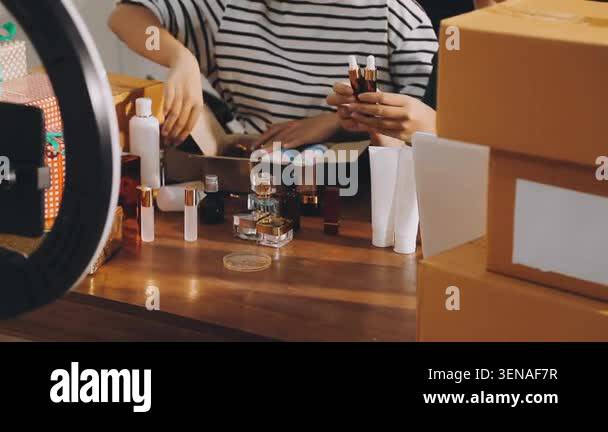 a girl in a black shirt and a white shirt holding a box with a glass of ...